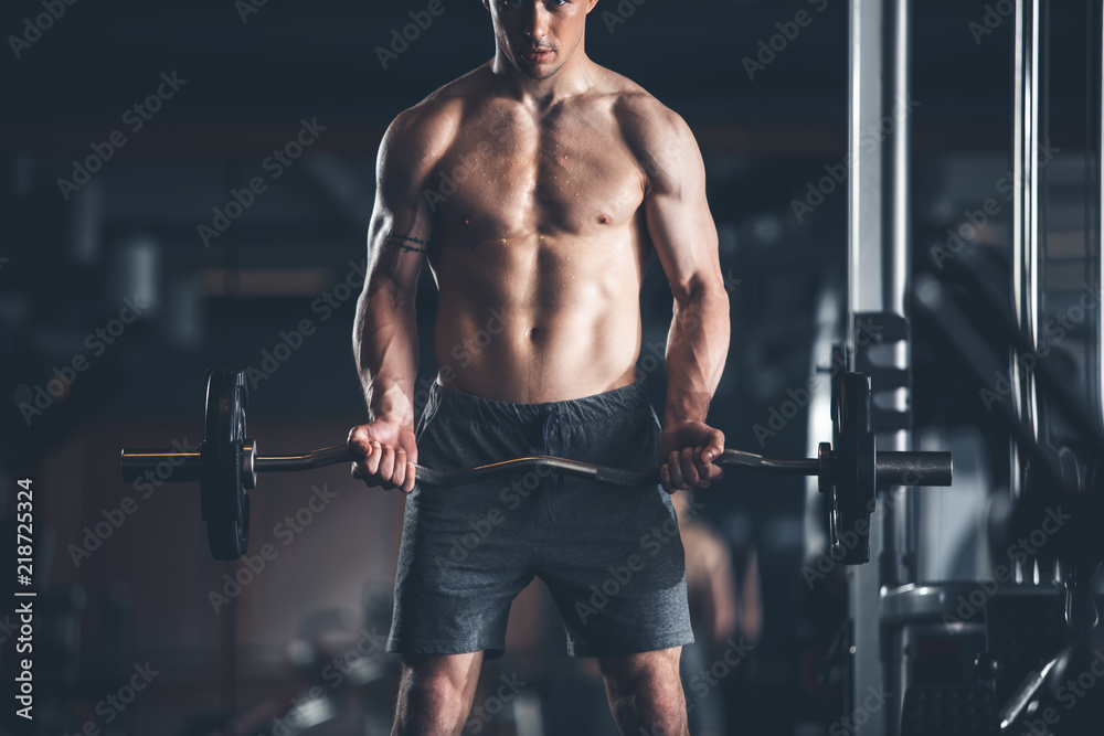 Bodybuilder is straining all body while making effort during workout ...