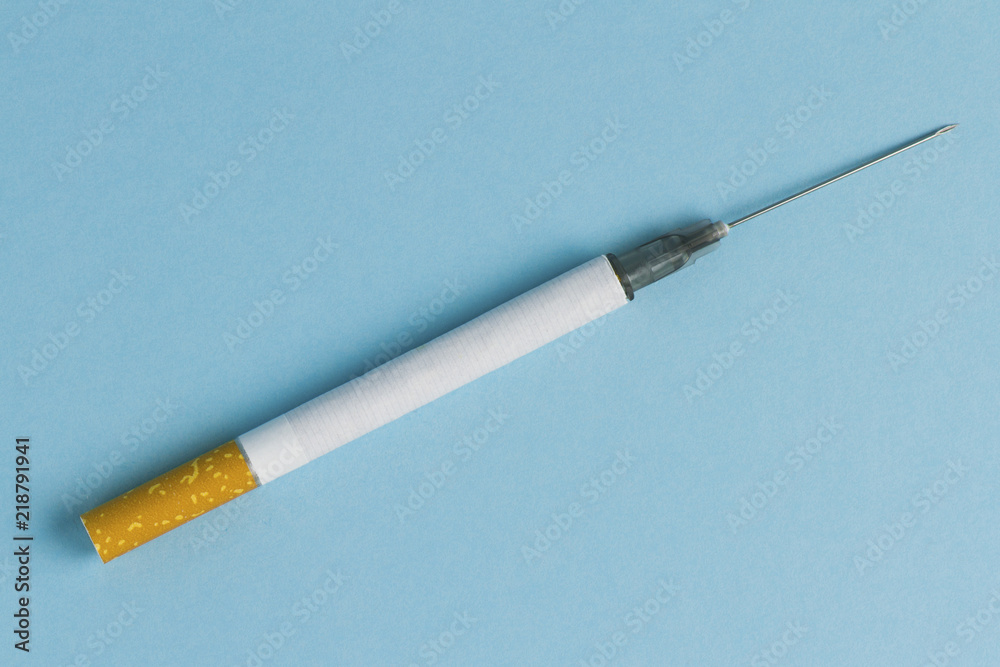 Cigarettes and needles for injections on a blue background. The concept ...