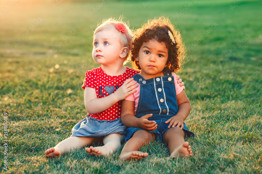 Group portrait of two cute adorable girls toddlers children sitting ...