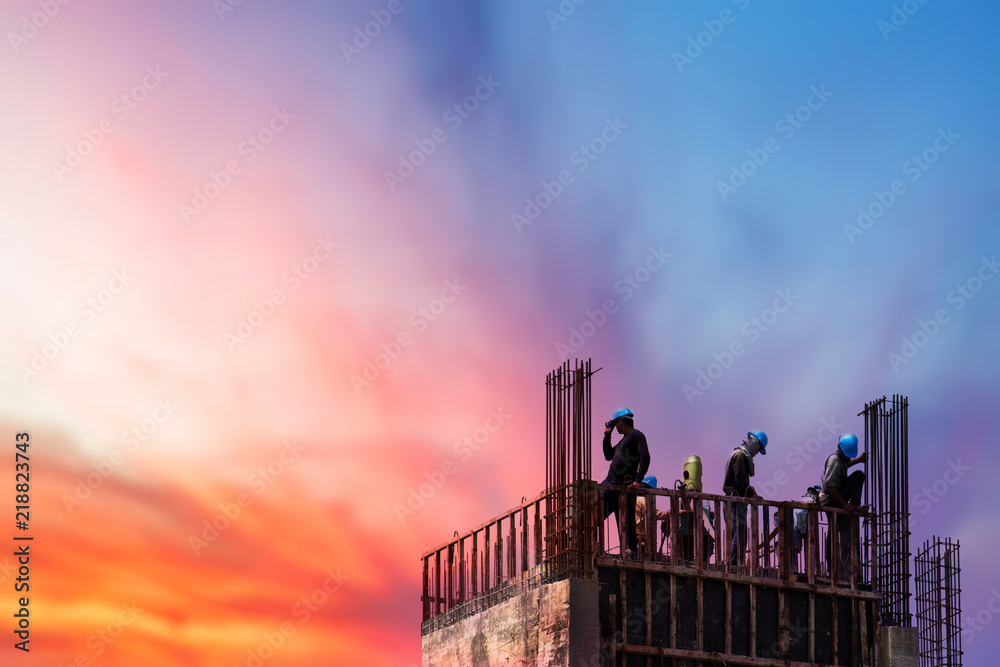 Construction workers working at height at the construction site.They ...