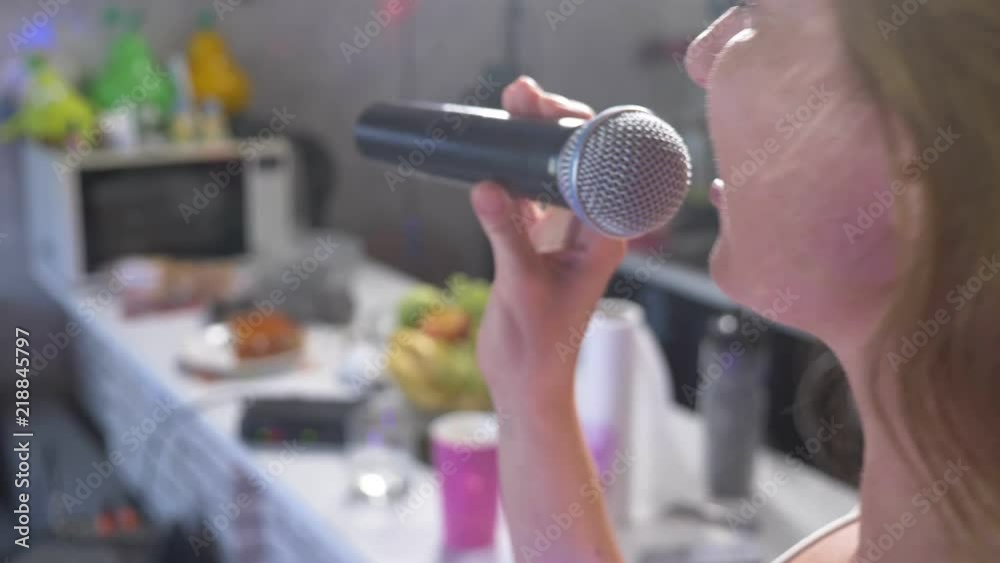 Close up. a woman screaming to a microphone. a woman sings karaoke into ...