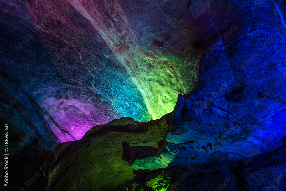 Abstract cave interior chamber photograph - colored lights, bumpy rock ...