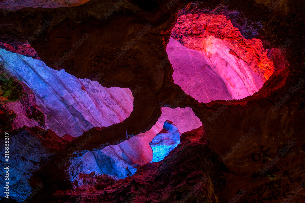 Abstract cave interior chamber photograph - colored lights, bumpy rock ...