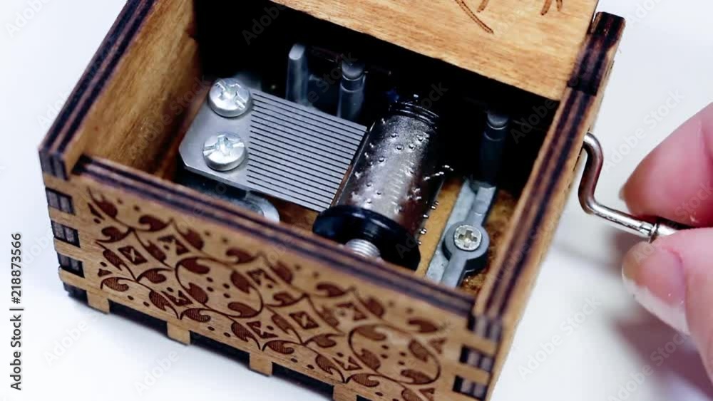 Woman's hand opening and playing a music box. Macro of the music box ...