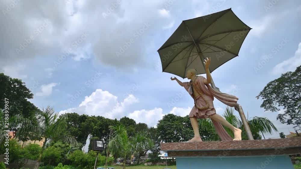 A timelapse of statue of Indian demi god Chaitanya Deb with umbrella ...
