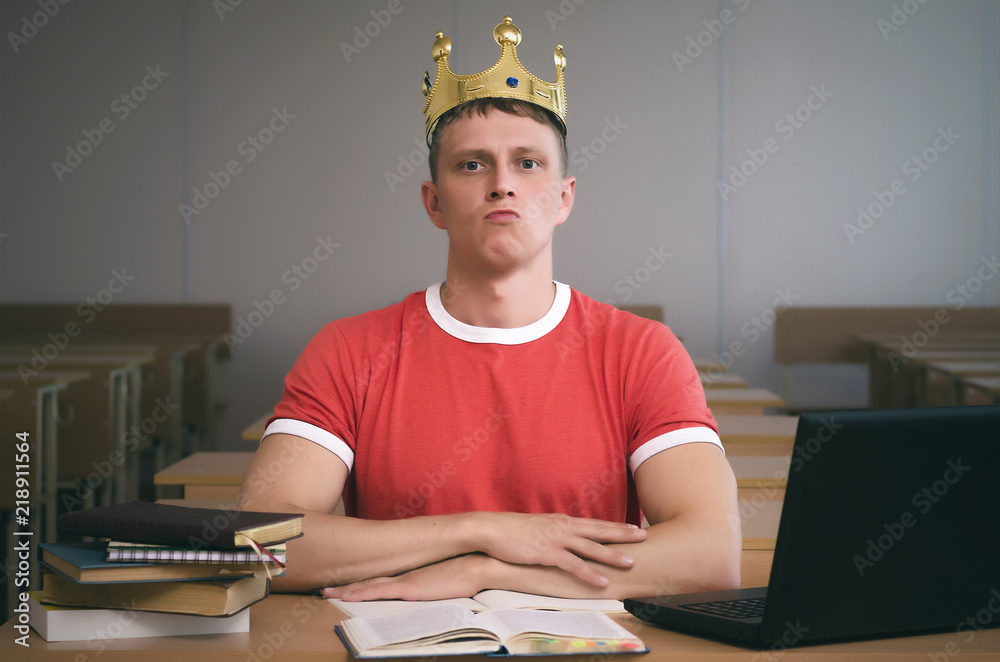 Arrogant student boy with golden crown above his head with an insolent ...