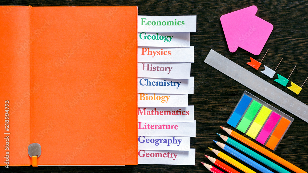 Orange notebook with the name of school subjects and with school ...