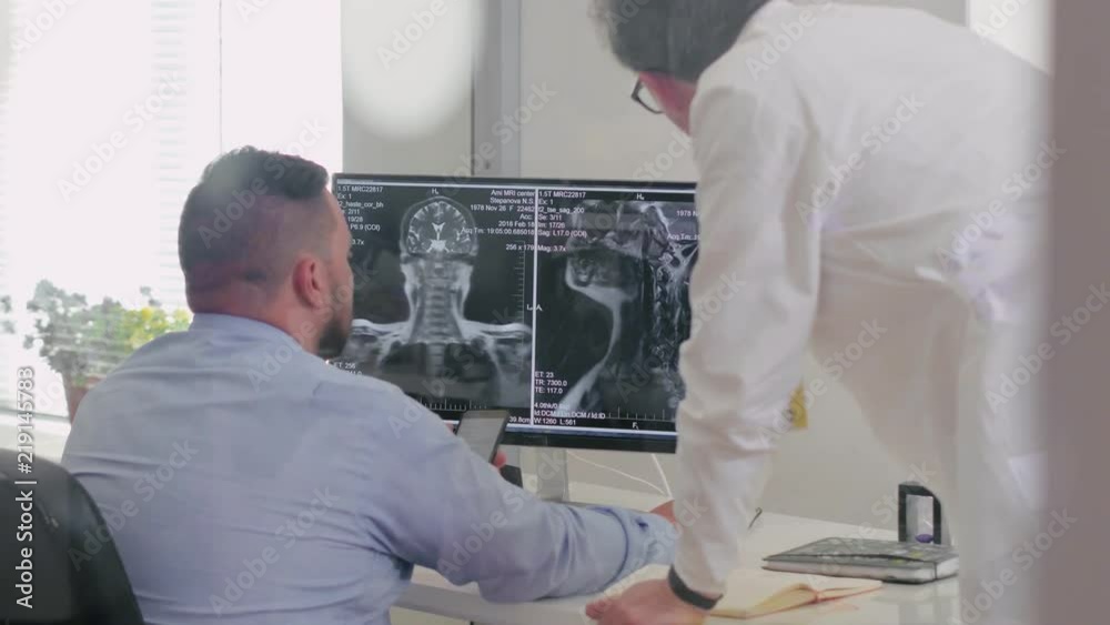 Doctors radiologists look at the computer screen x-ray picture of the ...