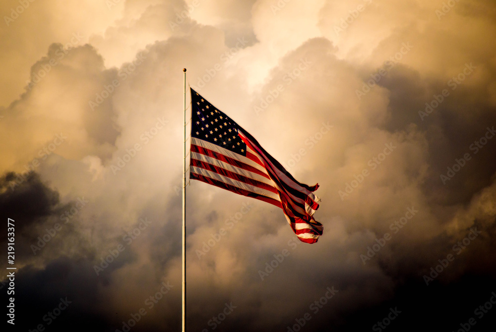 The American flag flies high as a storm approaches Stock Photo | Adobe ...