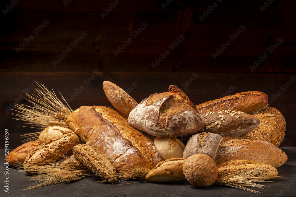 Composition of abundance of freshly baked loaves of bread and buns with ...