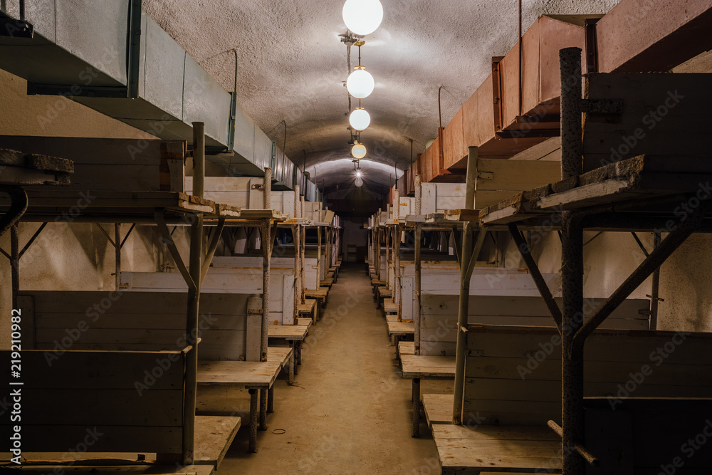 Wooden double-decker beds inside old abandoned soviet bomb shelter ...