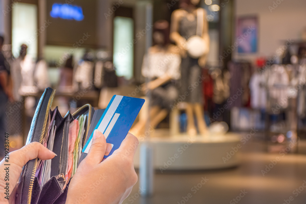 Female hand holding wallet and choose credit card for payment shopping ...