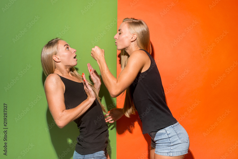 Angry women. Aggressive women standing isolated on trendy studio ...