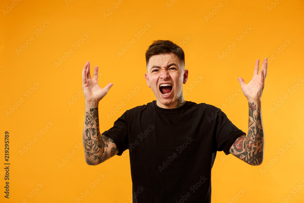 Screaming, hate, rage. Crying emotional angry man screaming on studio ...