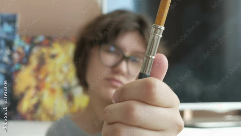 Artist measures the parameters for the image. Girl artist drawing a ...