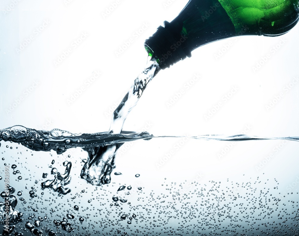 Water Pouring out of Plastic Bottle on the Grey background Stock Photo ...