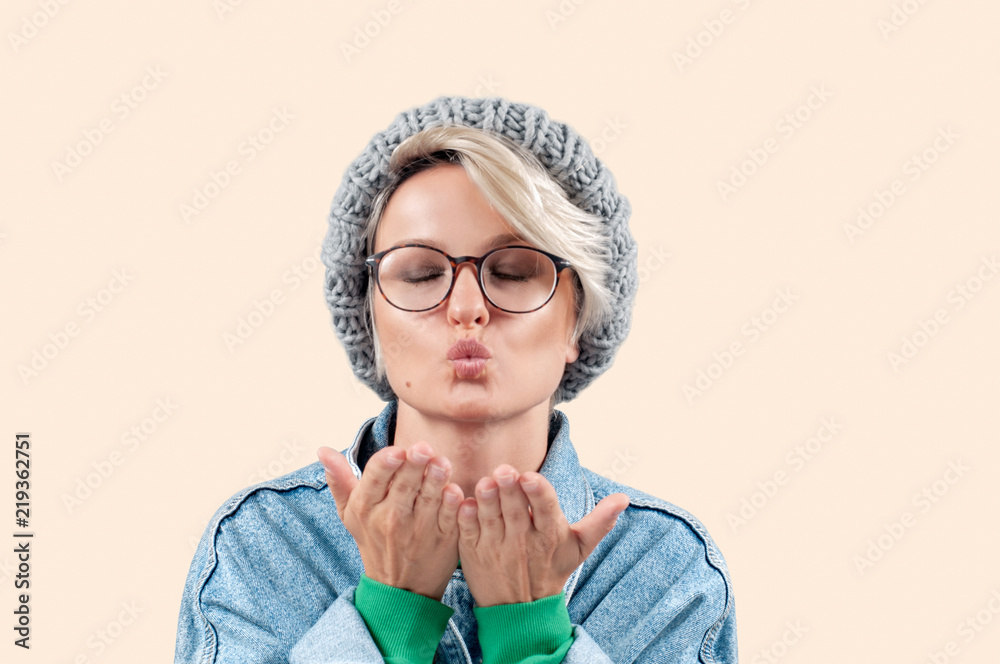 Beautiful woman posing with kiss face expression on pastel background ...