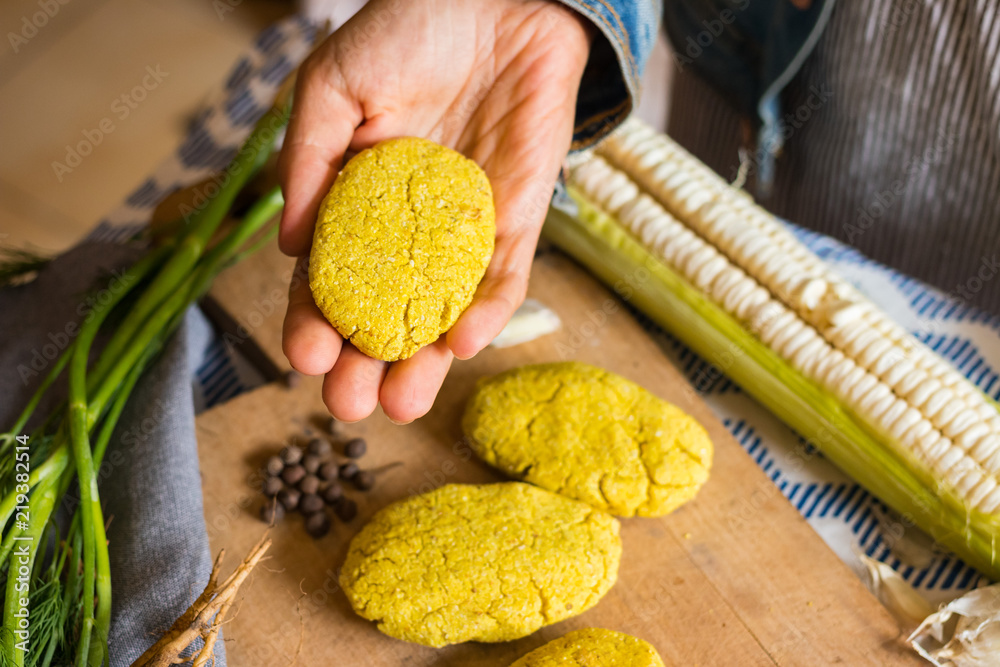 Woman hand holds Mchadi - traditional white corn flour Georgian bread ...