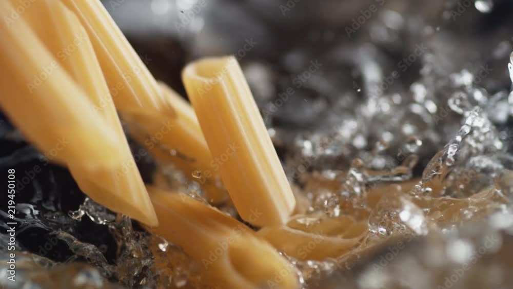 Throwing penne pasta into water. Shot with high speed camera, phantom ...