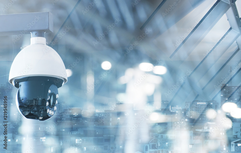 modern CCTV camera on a wall. A foggy day in a city background image ...