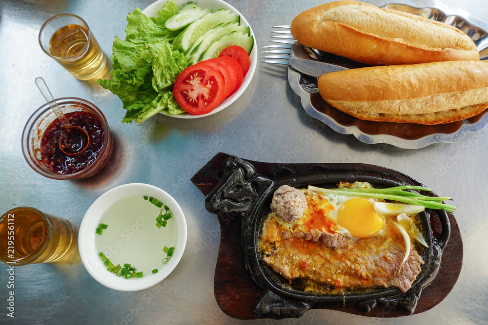 Bo Ne, a traditional Vietnamese breakfast with steak, eggs and crispy ...