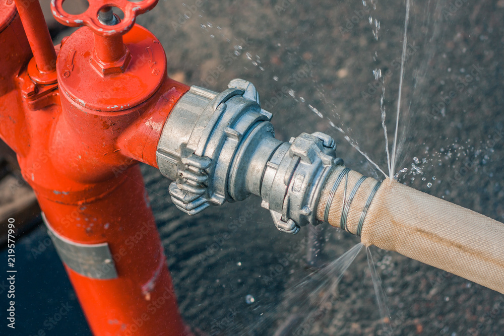 Damaged fire hose from a fire hydrant - water spray Stock Photo | Adobe ...