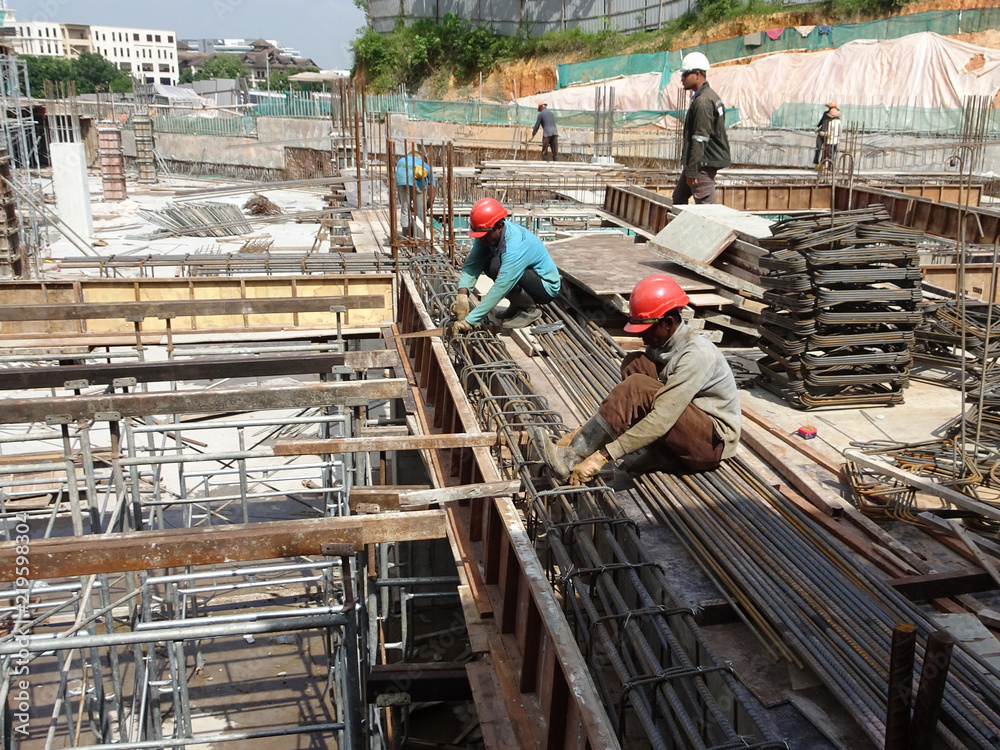 Construction workers installing reinforcement bar at the construction ...