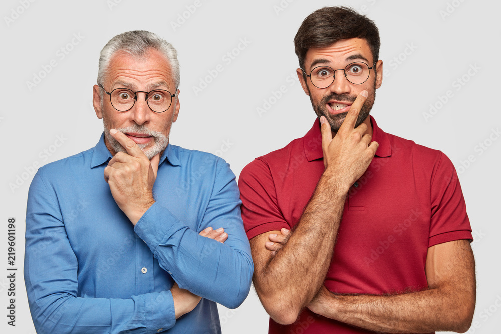 People, generation and progeny concept. Astonished father and son hold ...