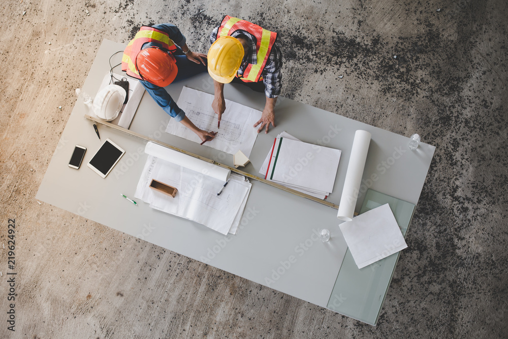 Top view of architects and engineers to help create a blueprint to ...
