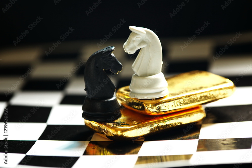 Gold bar on chess board scene. Stock Photo | Adobe Stock