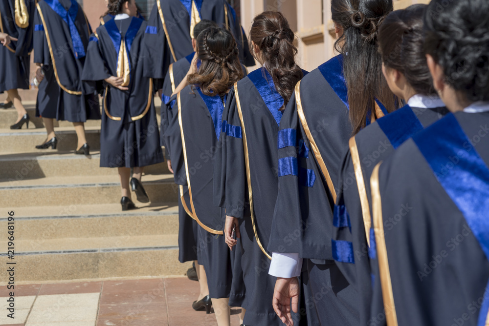 The graduates entered the auditorium to attend the graduation ceremony ...