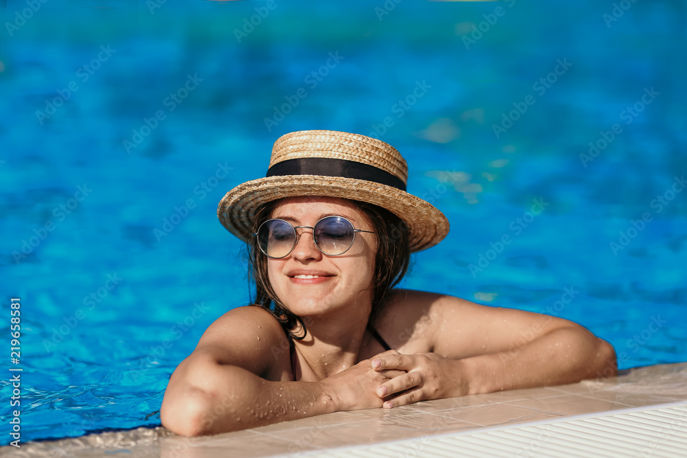 Beautiful woman in a swimming pool having sunbathe Stock Photo | Adobe ...