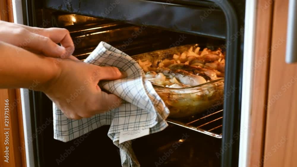 the woman takes out the cooked dish from the oven Stock Video | Adobe Stock