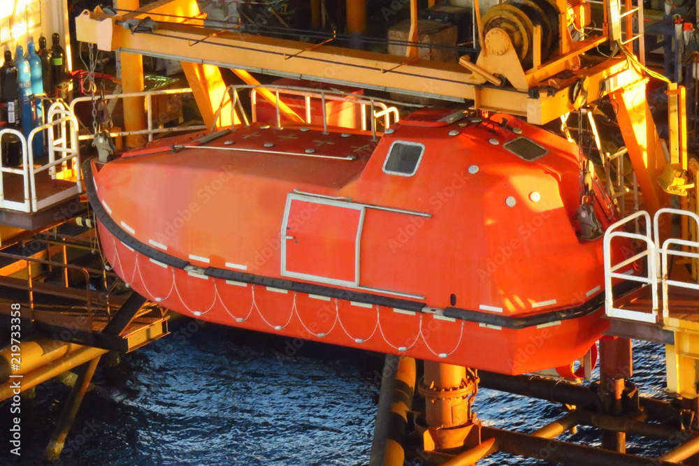 Offshore Life boat or survival craft at muster station of oil and gas ...