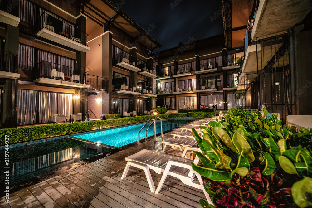 long exposure night shot image of poolside resort building with ...