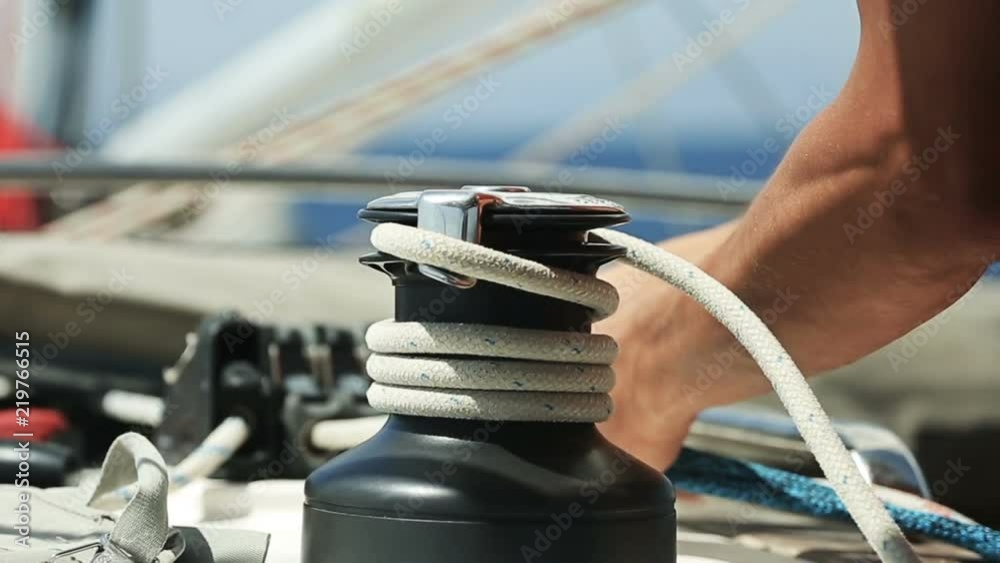Hands of male yachtsman pulling ropes on the yahts. Man with strong arm ...