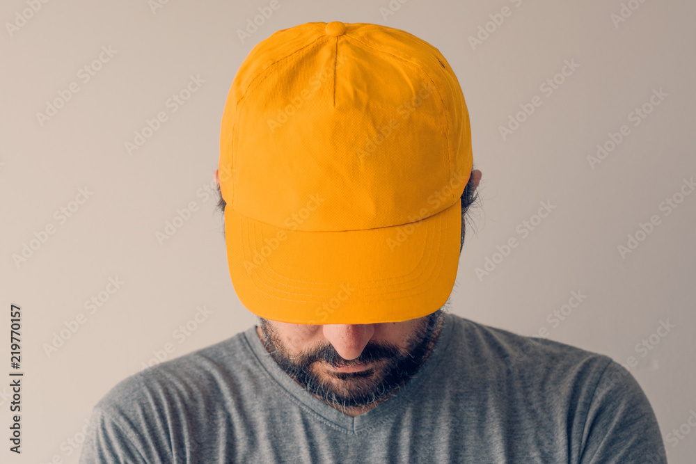 Man wearing yellow baseball cap for mockup Stock Photo | Adobe Stock