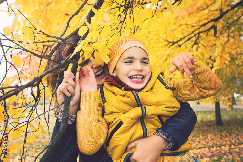 Smiling little boy, kid with disabilities and his mother. Child has ...