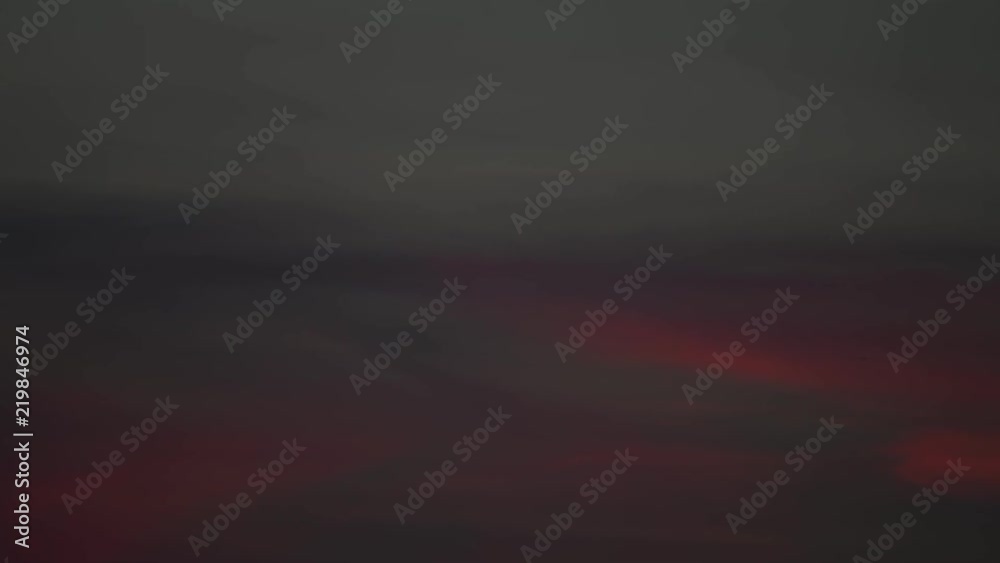 Time lapse of dramatic red sky with clouds getting dark at sunset ...