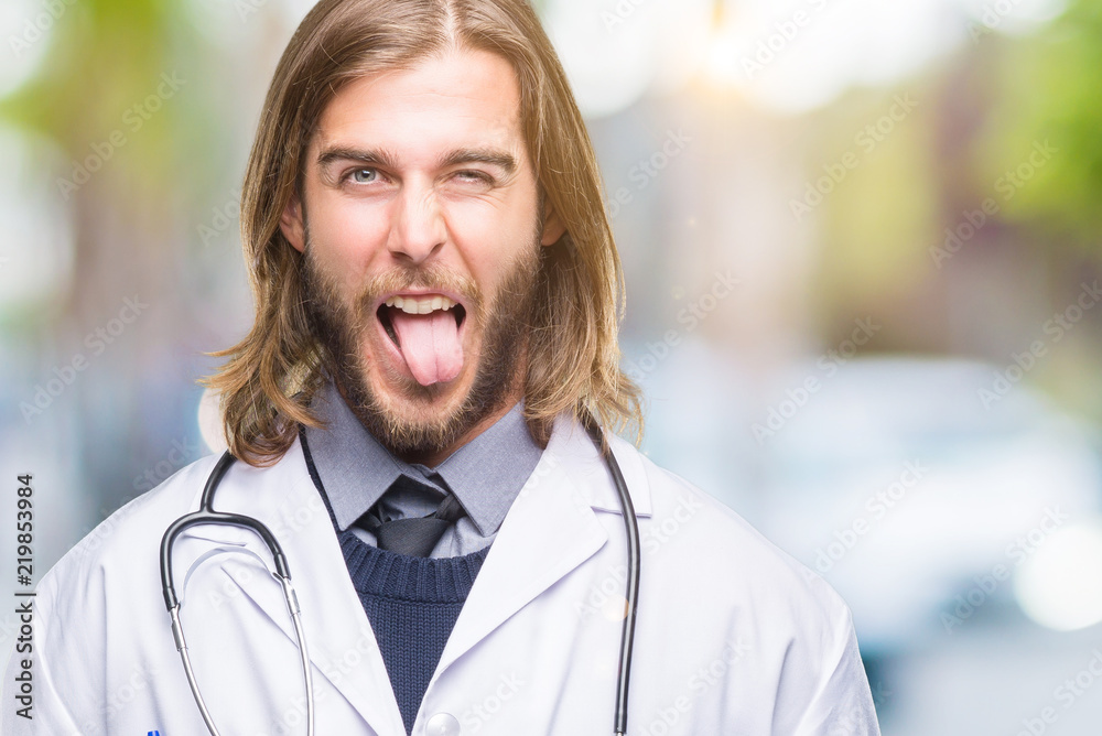 Young handsome doctor man with long hair over isolated background ...