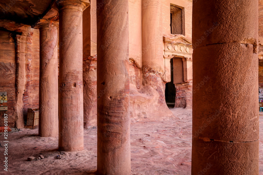 Antique building carved in sandstone with visible colums and open doors ...
