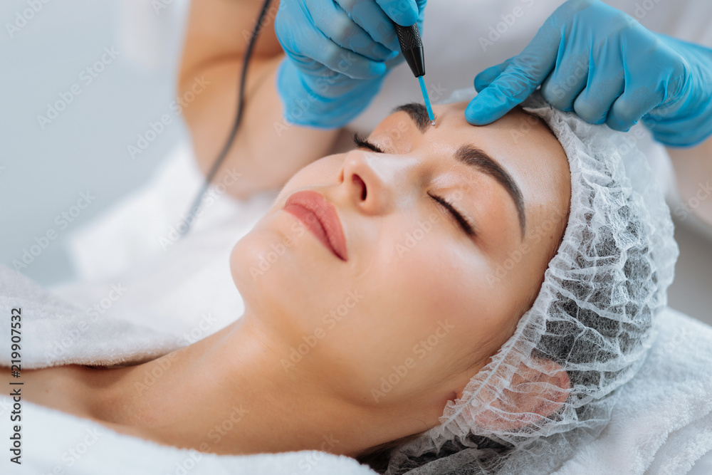 Dermatology procedure. Portrait of a beautiful nice woman lying with ...