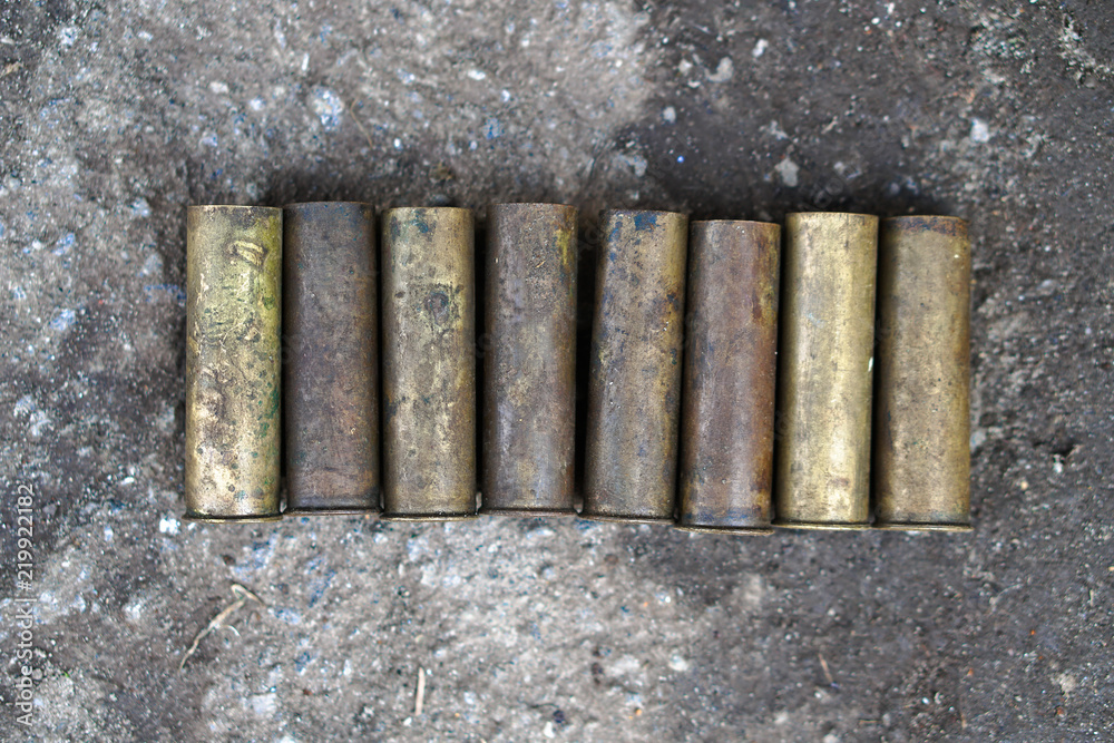 Sleeve from the gun on the background of a concrete structure. Military ...