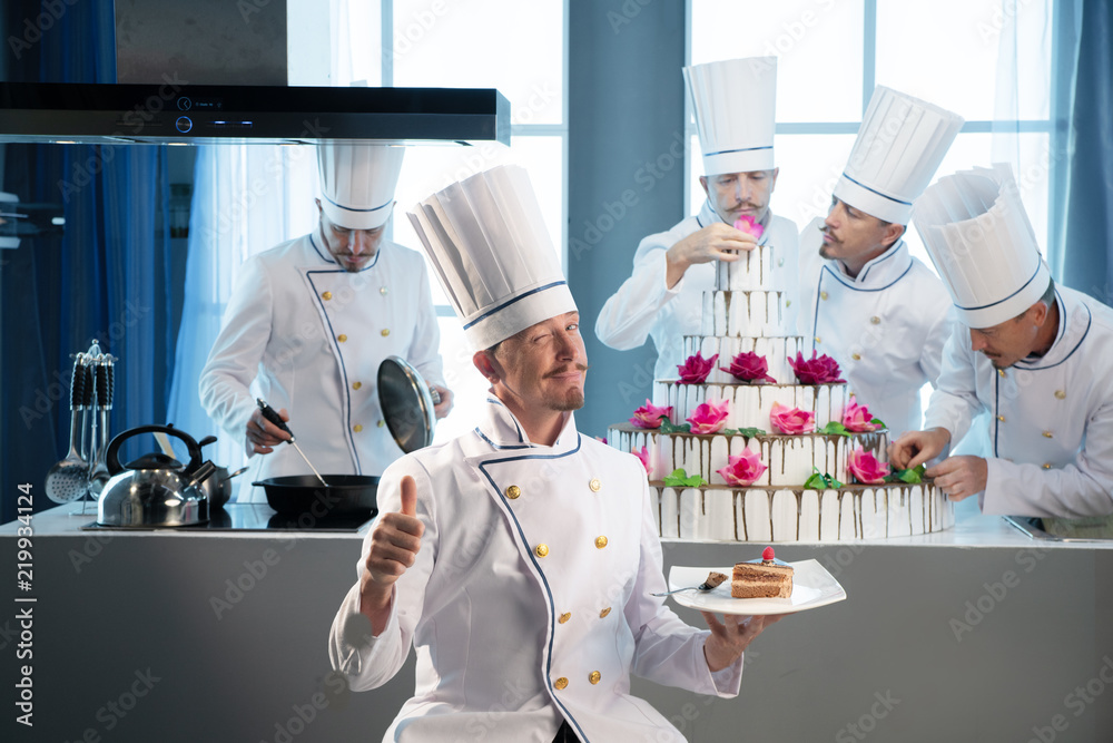 Poster A team of cooks preparing a huge cake for the celebration – Wall ...