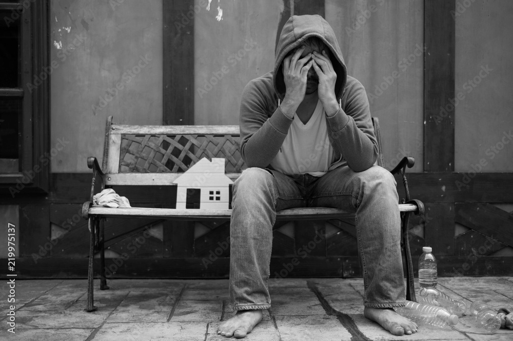 Poor homeless man sitting on bench with a cardboard house,Black and ...