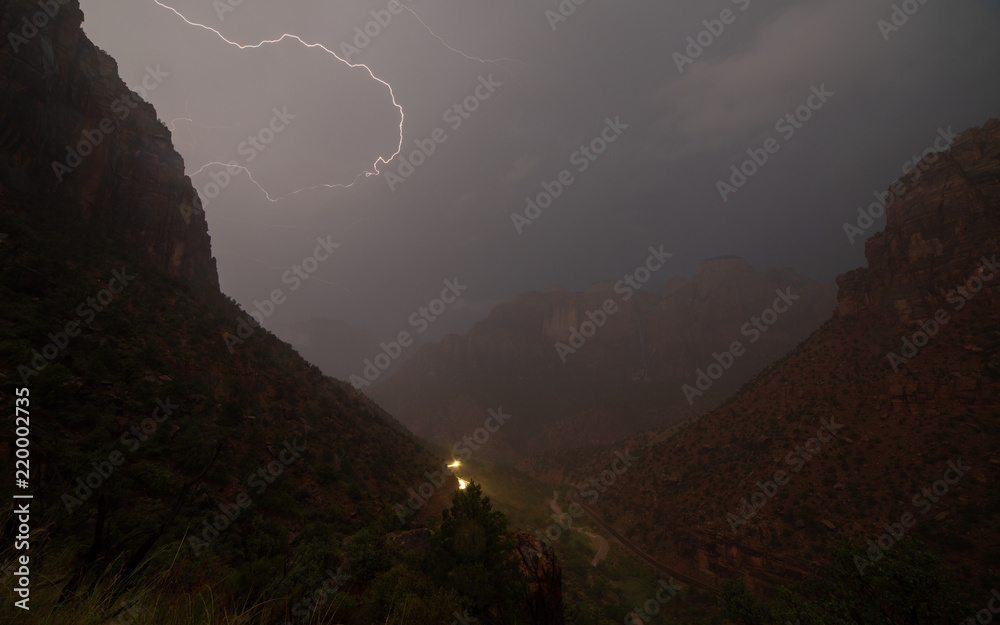 Lightning sheds a fitful light on some mountains while casting others ...