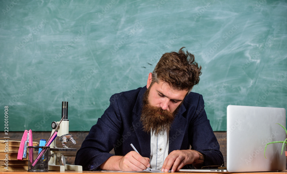 Writing report. Teacher bearded man writing with pen busy with ...