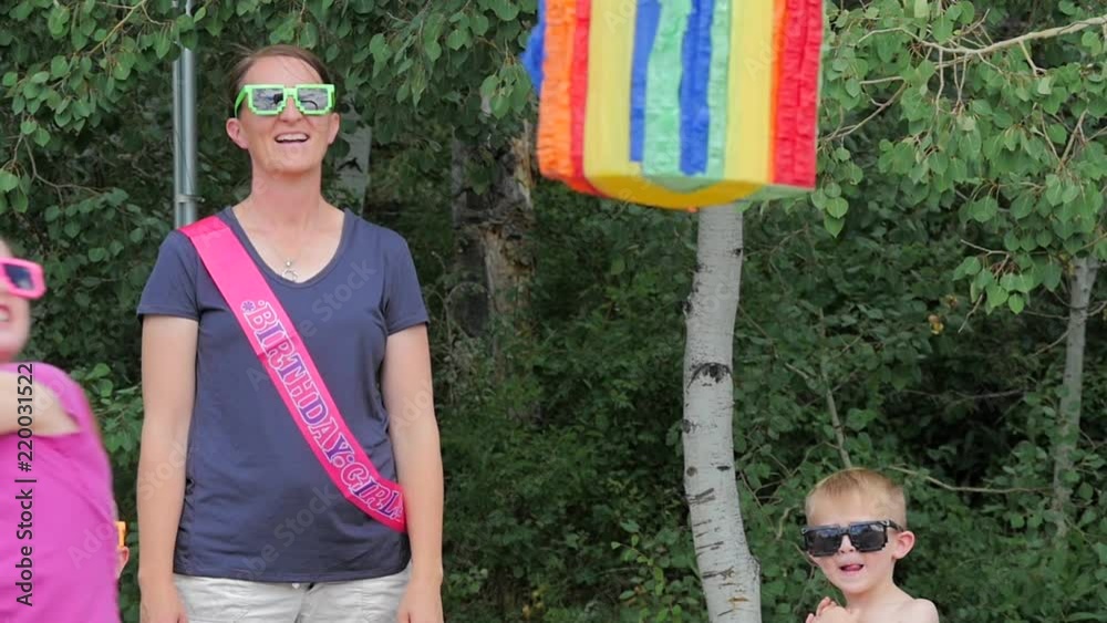 Young child hitting a pinata with a plastic bat. Stock ビデオ | Adobe Stock