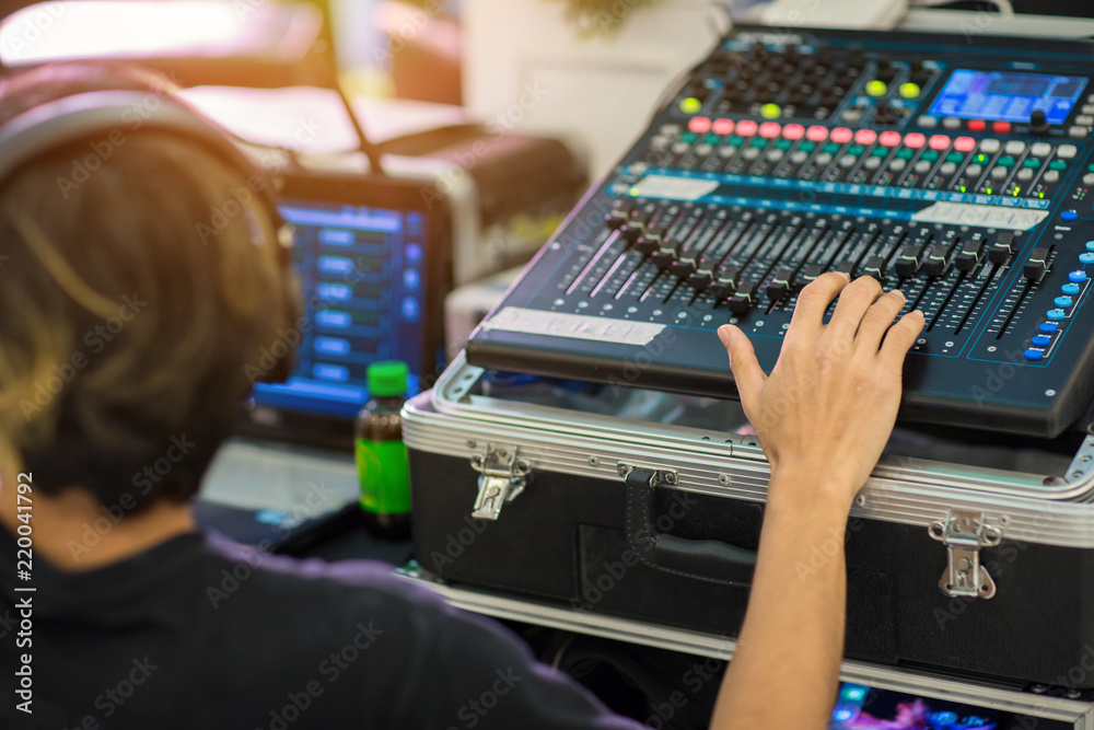 Blur Photo Hand adjusting audio mixer. sound engineer hands working on ...