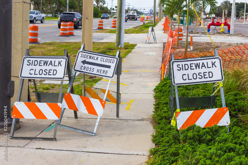 Construction safety sign warns pedestrians the sidewalk is closed at ...